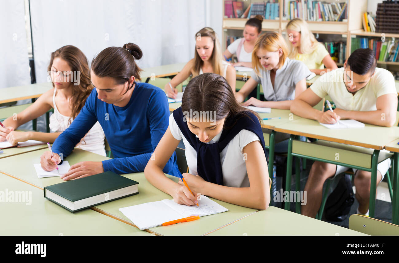 Serious student listening attentively during lecture in the classroom ...