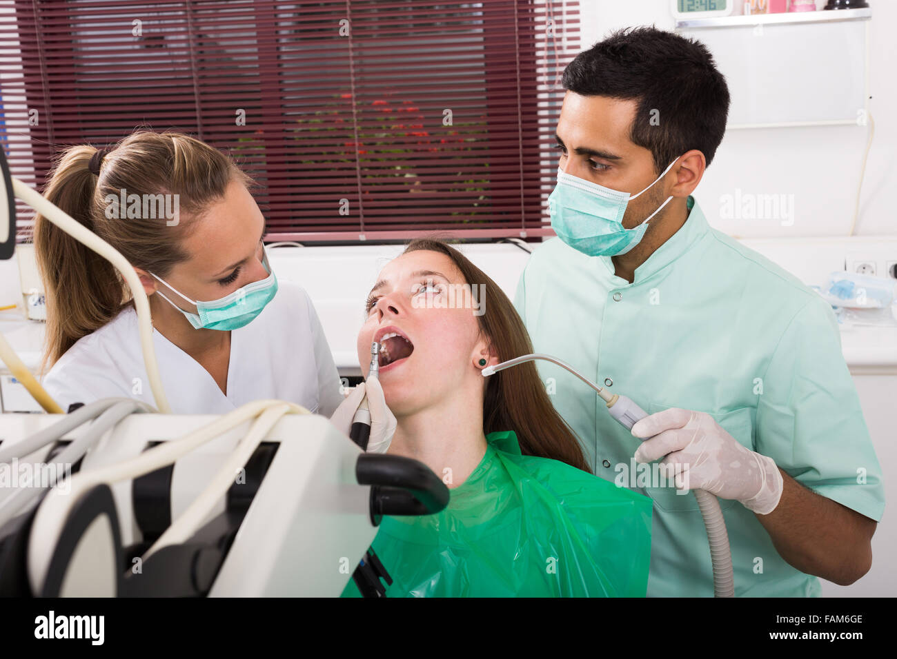 Sad patient checking out her teeth at dentist Stock Photo - Alamy