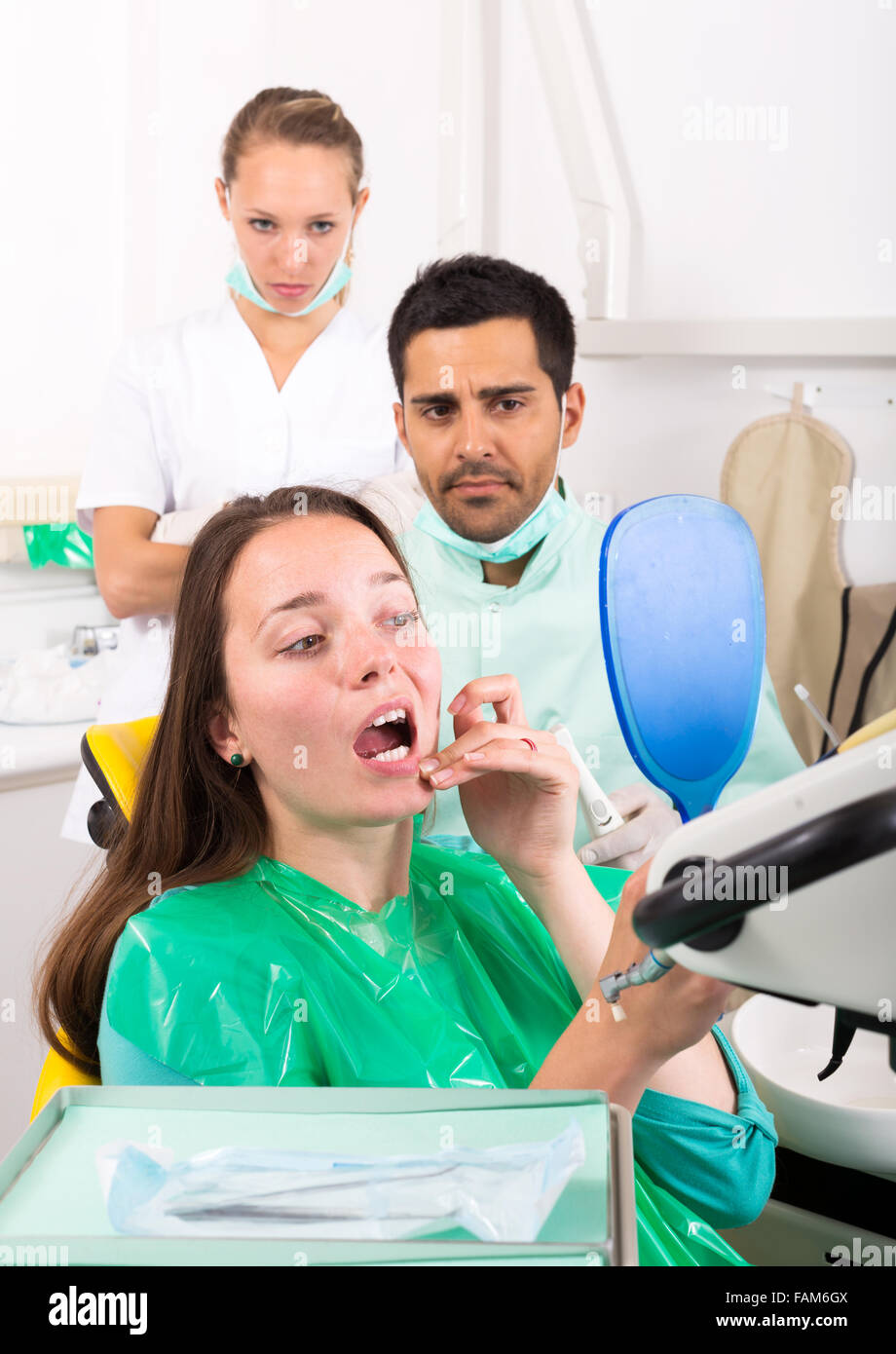 Female adult patient detecting problems on inspection at the dentist ...