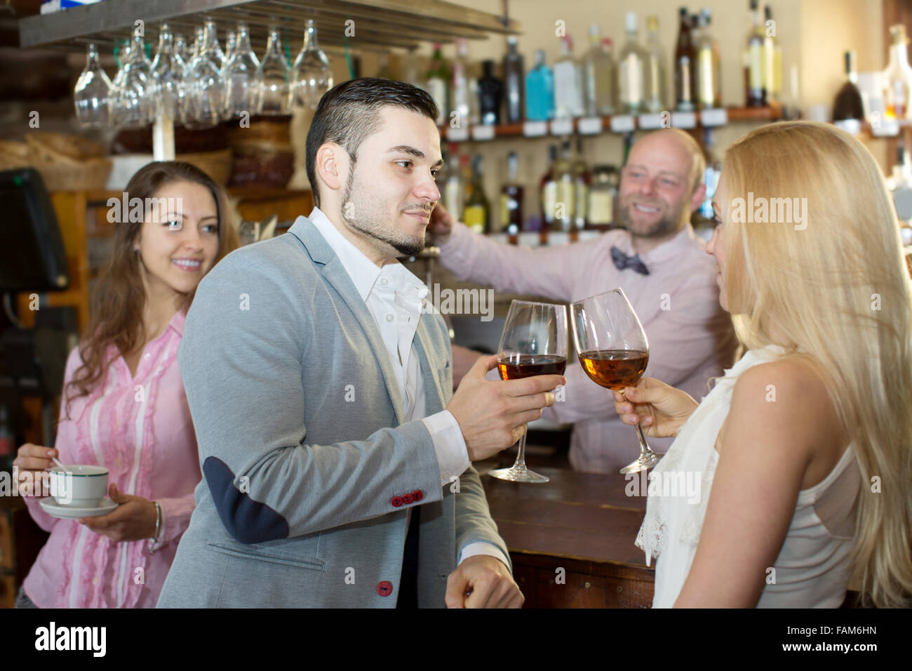 Restaurant smiling visitors waiting for table and drinking wine at ...