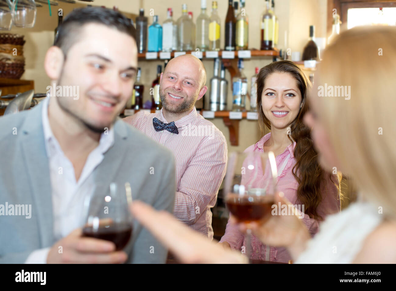 Portrait restaurant adult visitors waiting for table and drinking wine ...