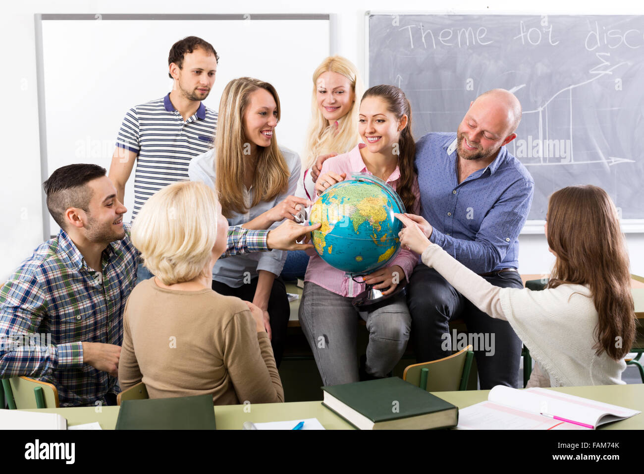 Happy teacher and adult students during break in classroom Stock Photo ...