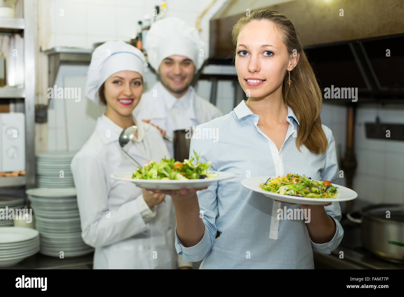 Beautiful young blonde female waiter taking dish from kitchen Stock ...