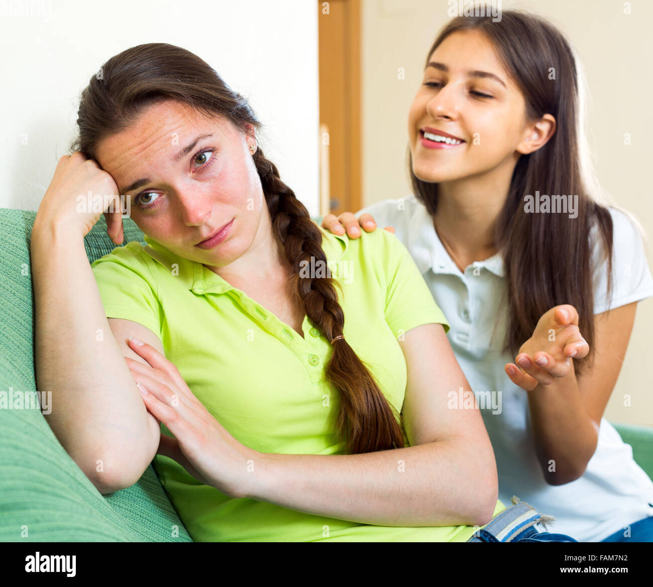 Sad young woman suffering from post break up depression is sitting on a ...