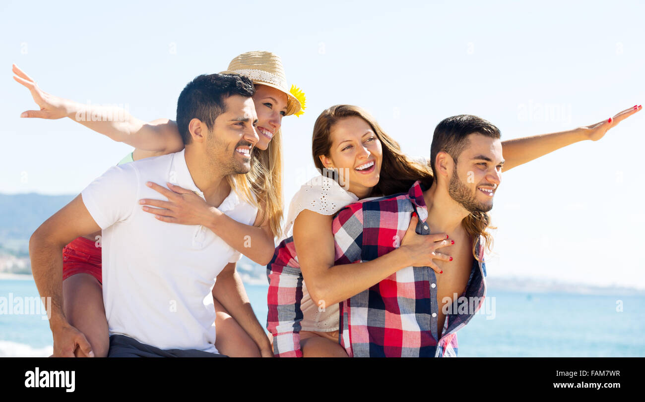 Happy young couples hugging on beach enjoying romance and sun Stock ...