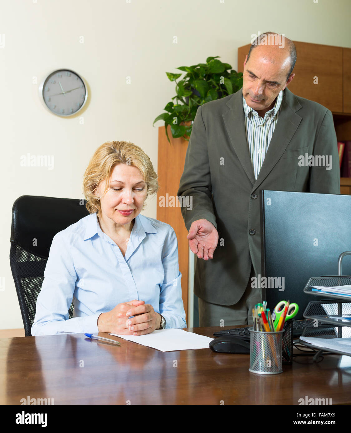 Angry boss scolding careless elderly female secretary for mistake at ...