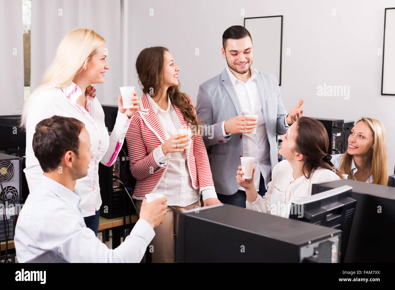 Employees and young manager celebrating good dealing Stock Photo - Alamy