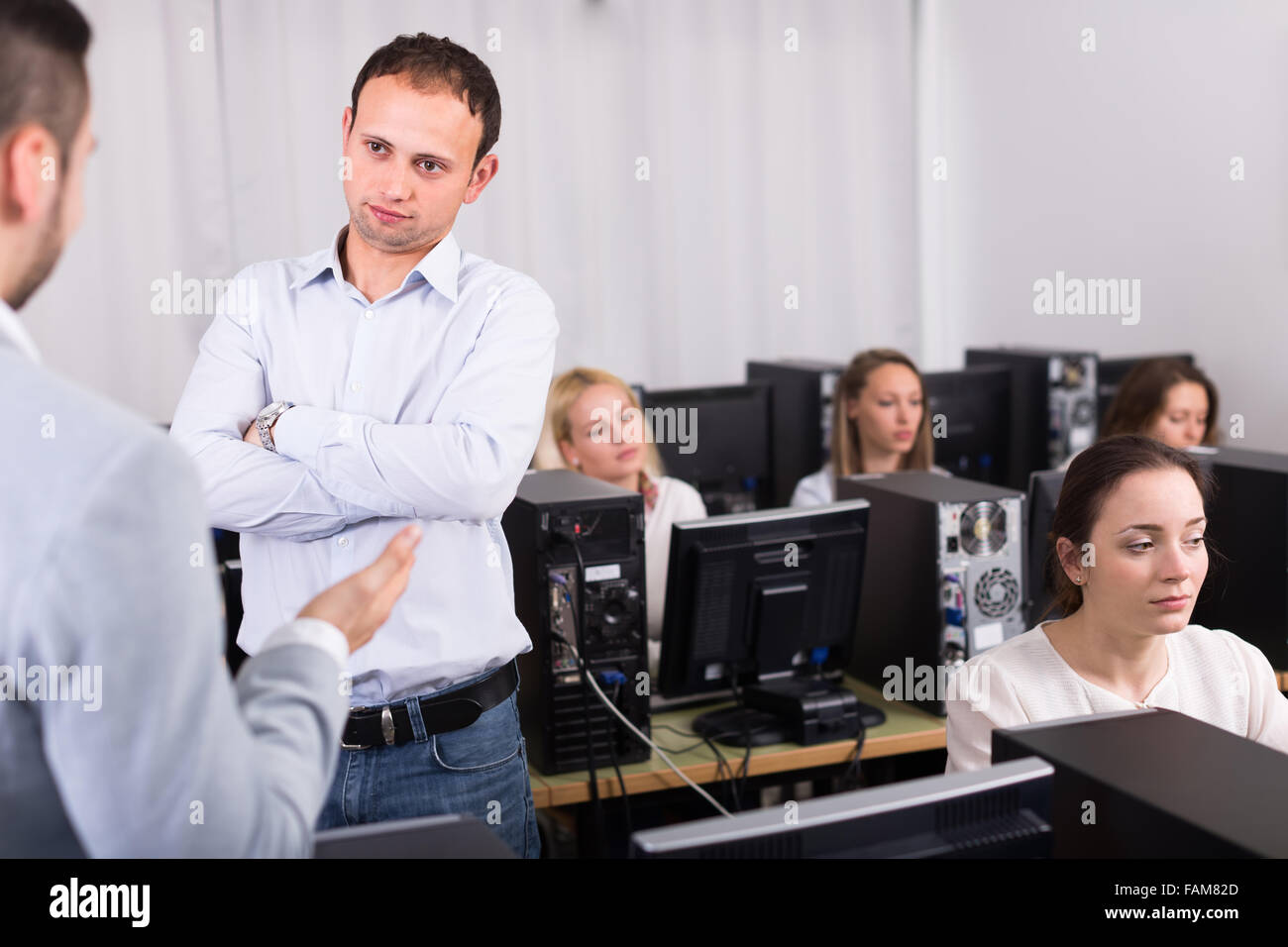 Furious supervisor scolding unhappy office worker at office Stock Photo ...