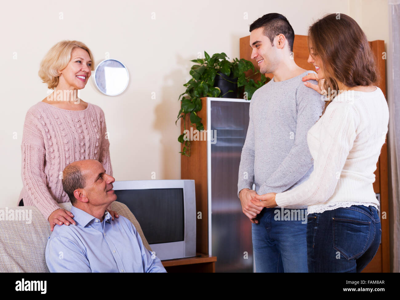 Adult daughter introducing boyfriend to parents at home Stock Photo - Alamy