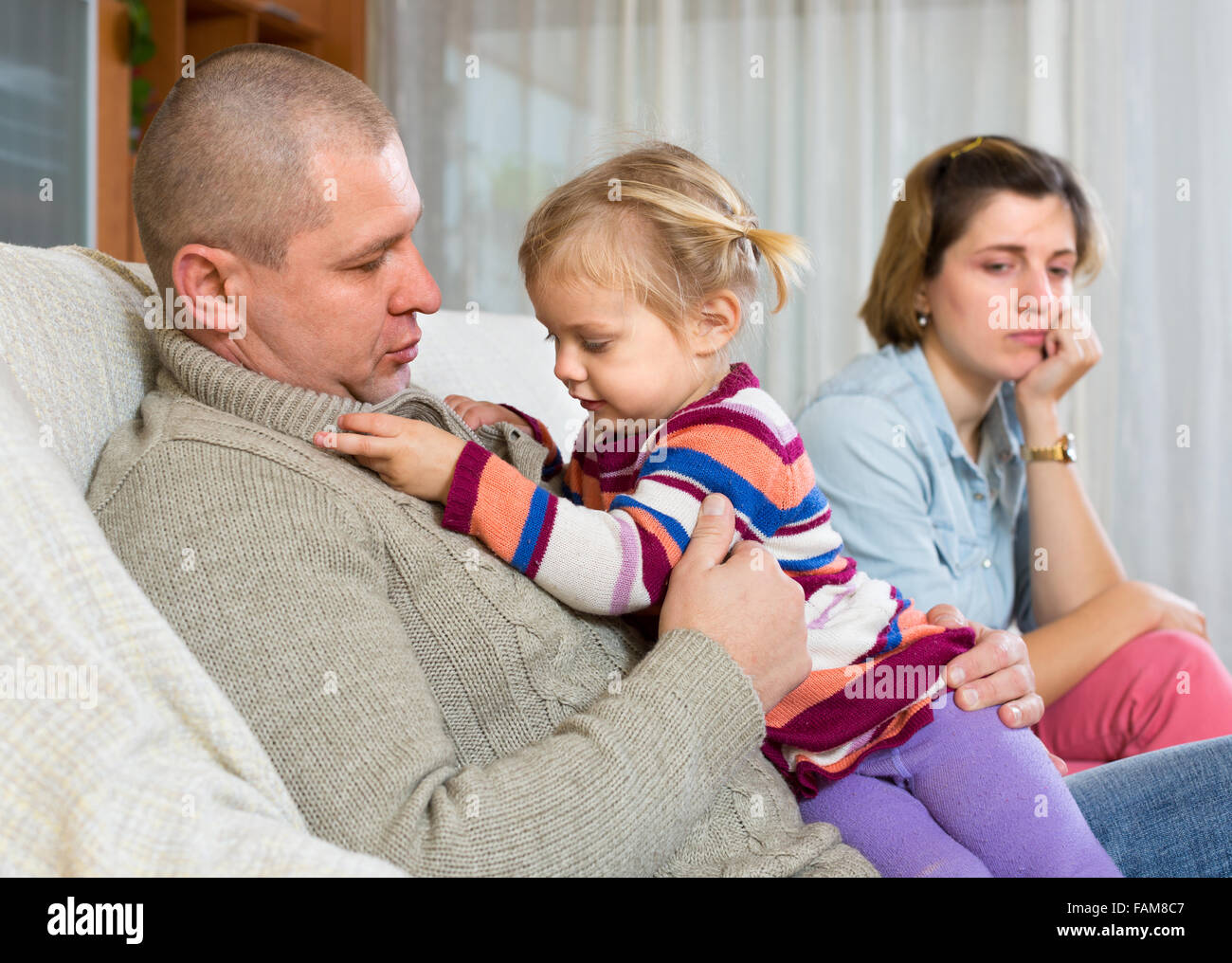 Family with little child having serious conflict at home Stock Photo ...