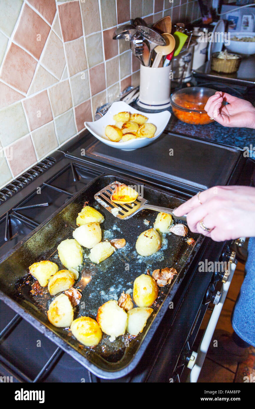 Roast potatoes roasted cooked cooking serving up roasting tray spuds on ...
