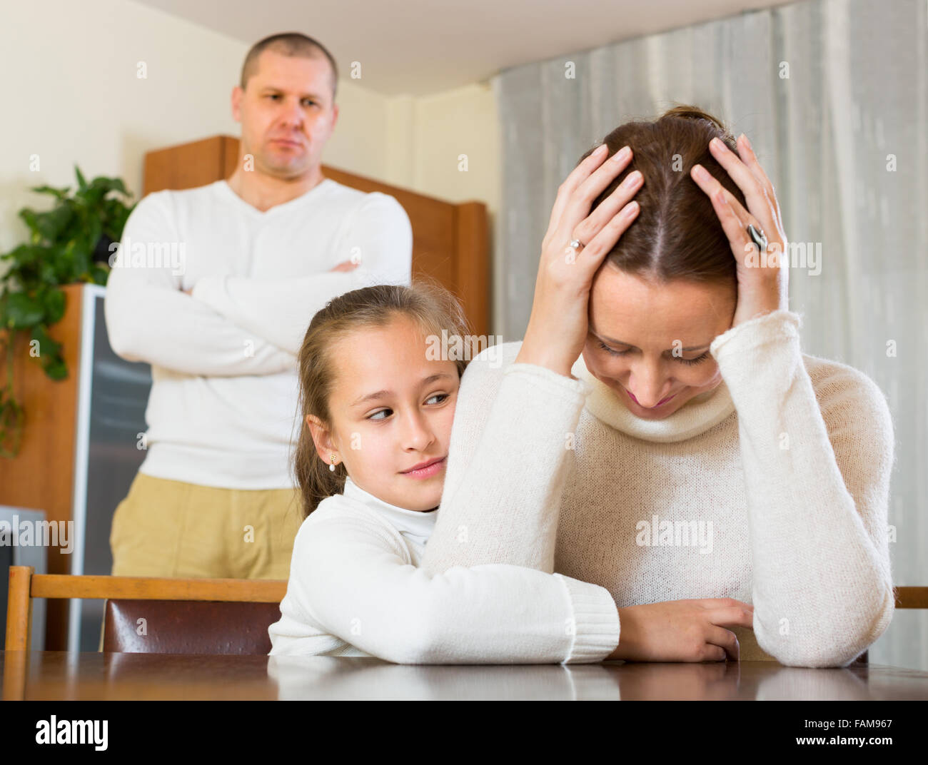 Family of three with daughter and angry man having conflict. Focus on ...