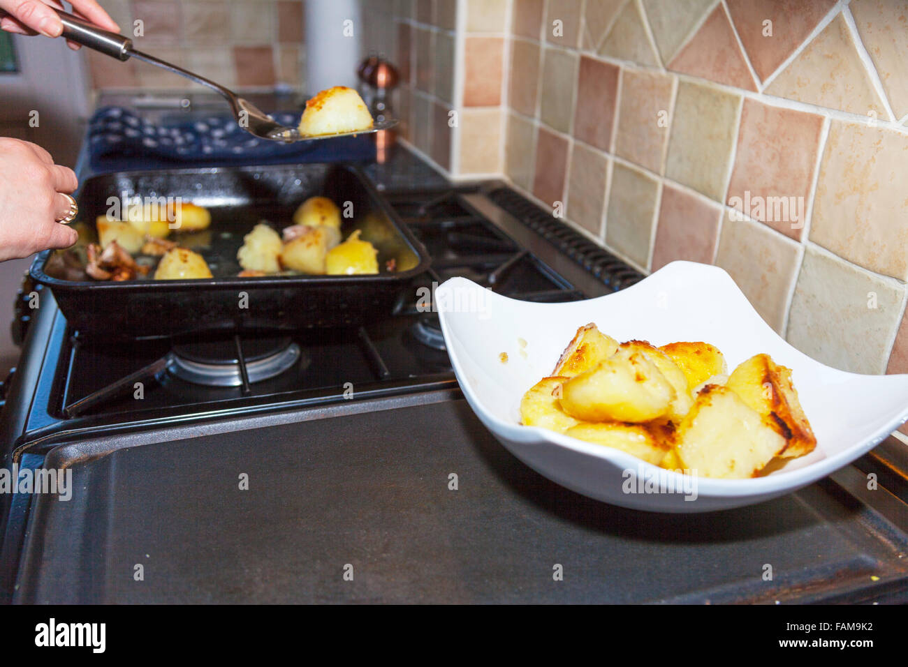 Roast potatoes roasted cooked cooking serving up roasting tray spuds on ...
