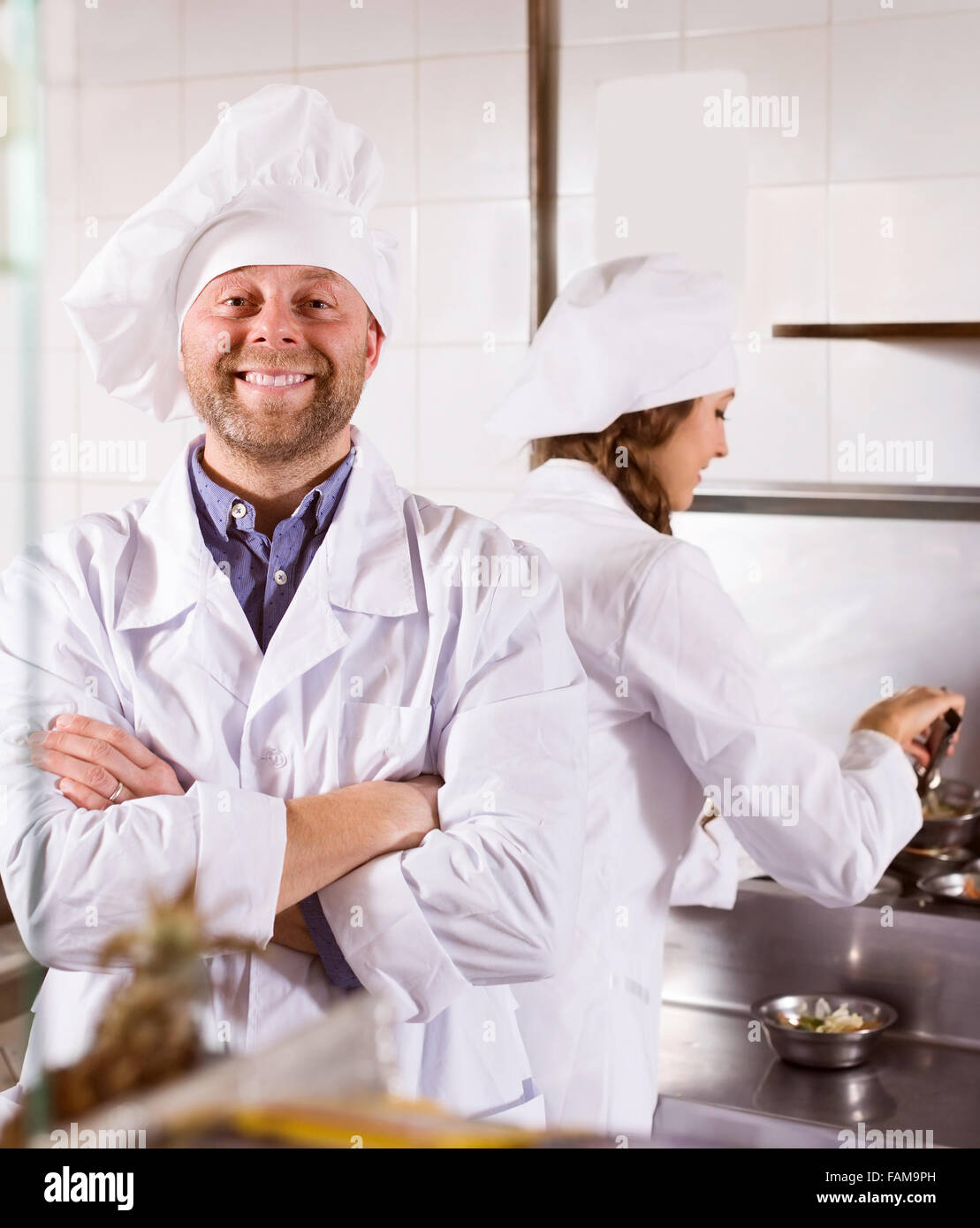 portrait adult male cook cooking at professional kitchen in the take ...