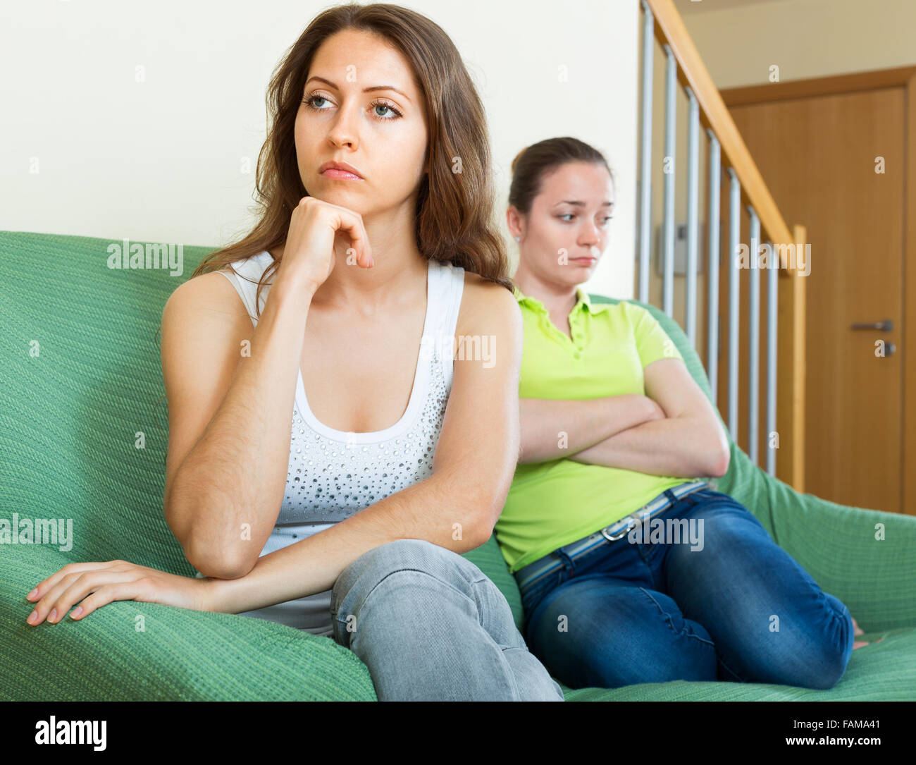 Two young beautiful women angry with each other at home Stock Photo - Alamy