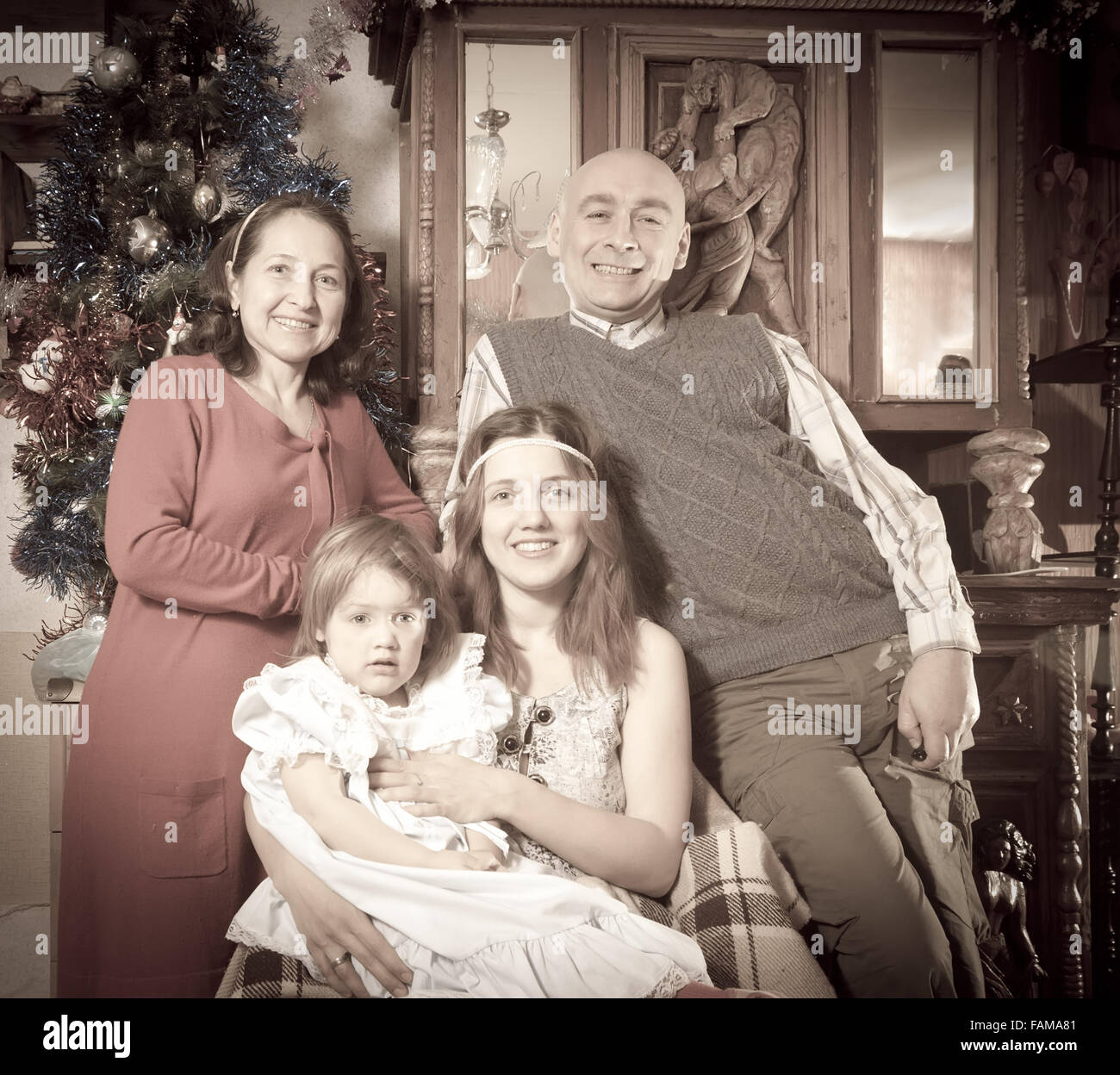 Imitation of aged photo of happy family of three generations at ...