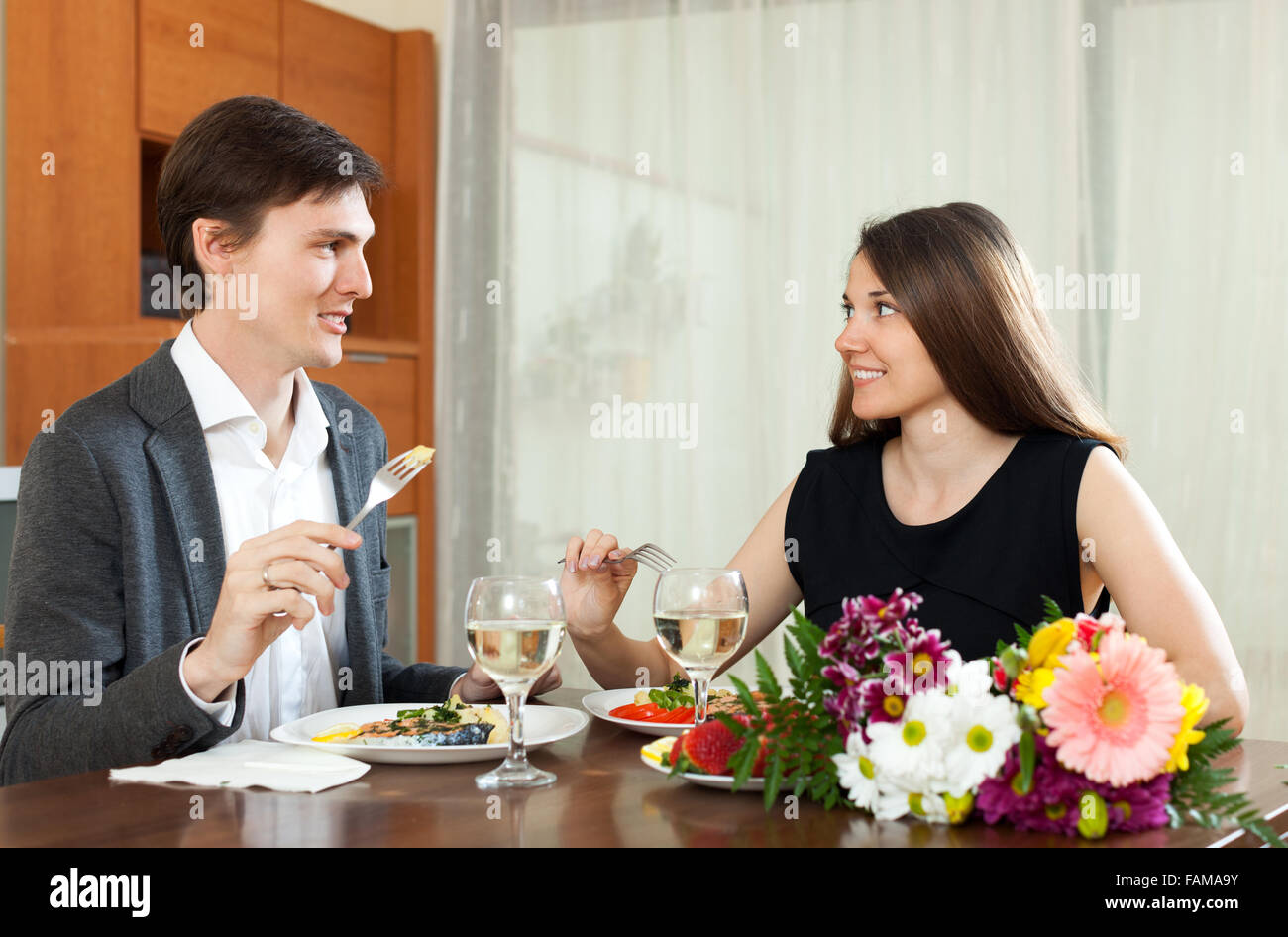 Cute man and woman having romantic dinner in home Stock Photo - Alamy