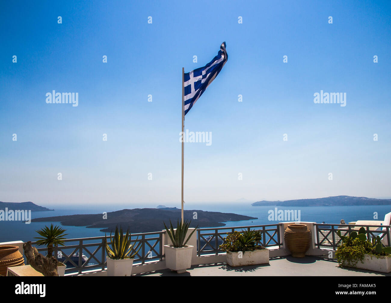 Waving Greek flag on viewing platform in Santorini, Greece, horizontal ...