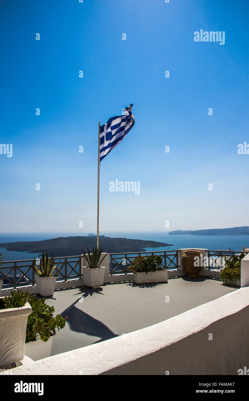 Waving Greek flag on viewing platform in Santorini, vertical Stock ...
