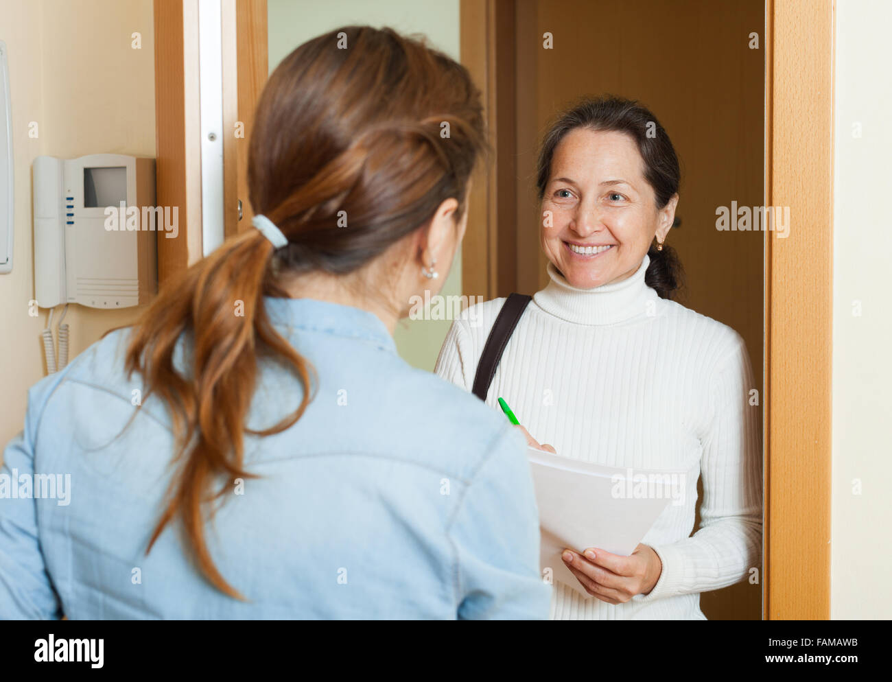 woman polling among people at home door Stock Photo - Alamy