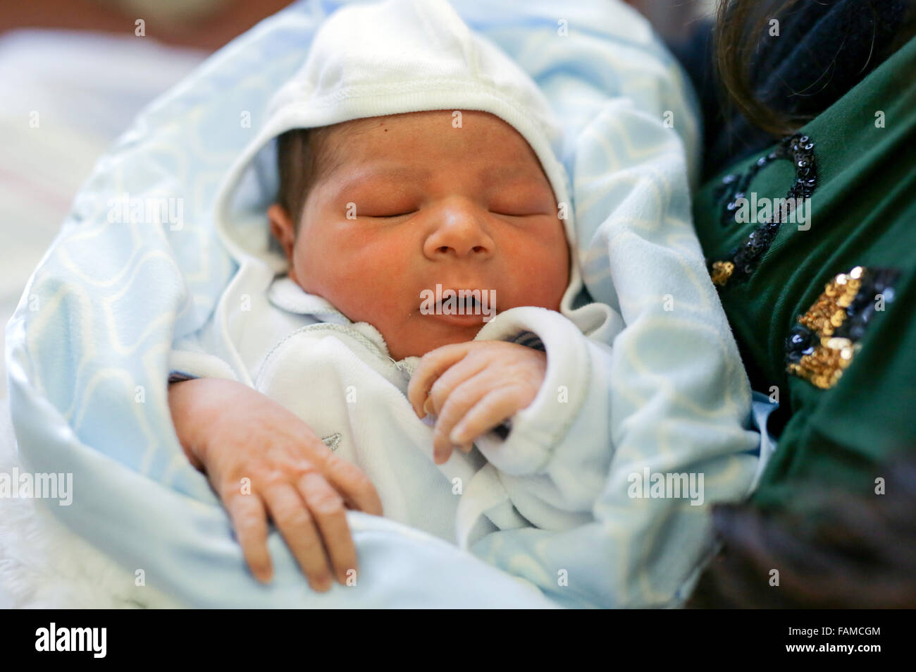 Hamburg's New Year's baby 'Aryan' sleeps in the arms of his mother in ...