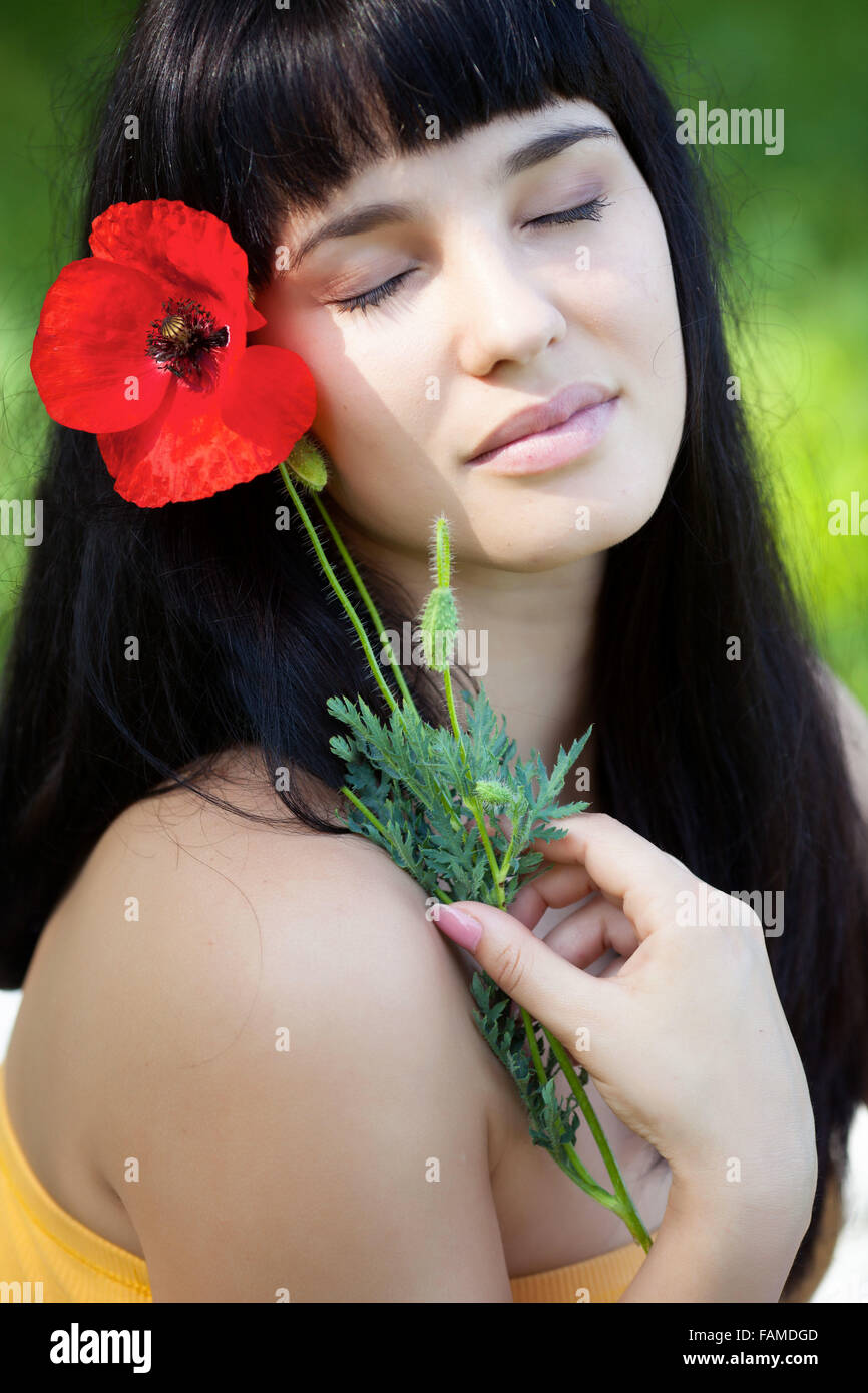Girl with poppy flower Stock Photo - Alamy