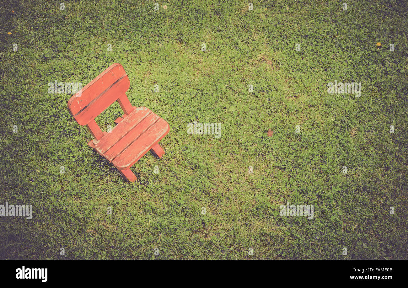 Empty wooden stool on green grass field Stock Photo - Alamy