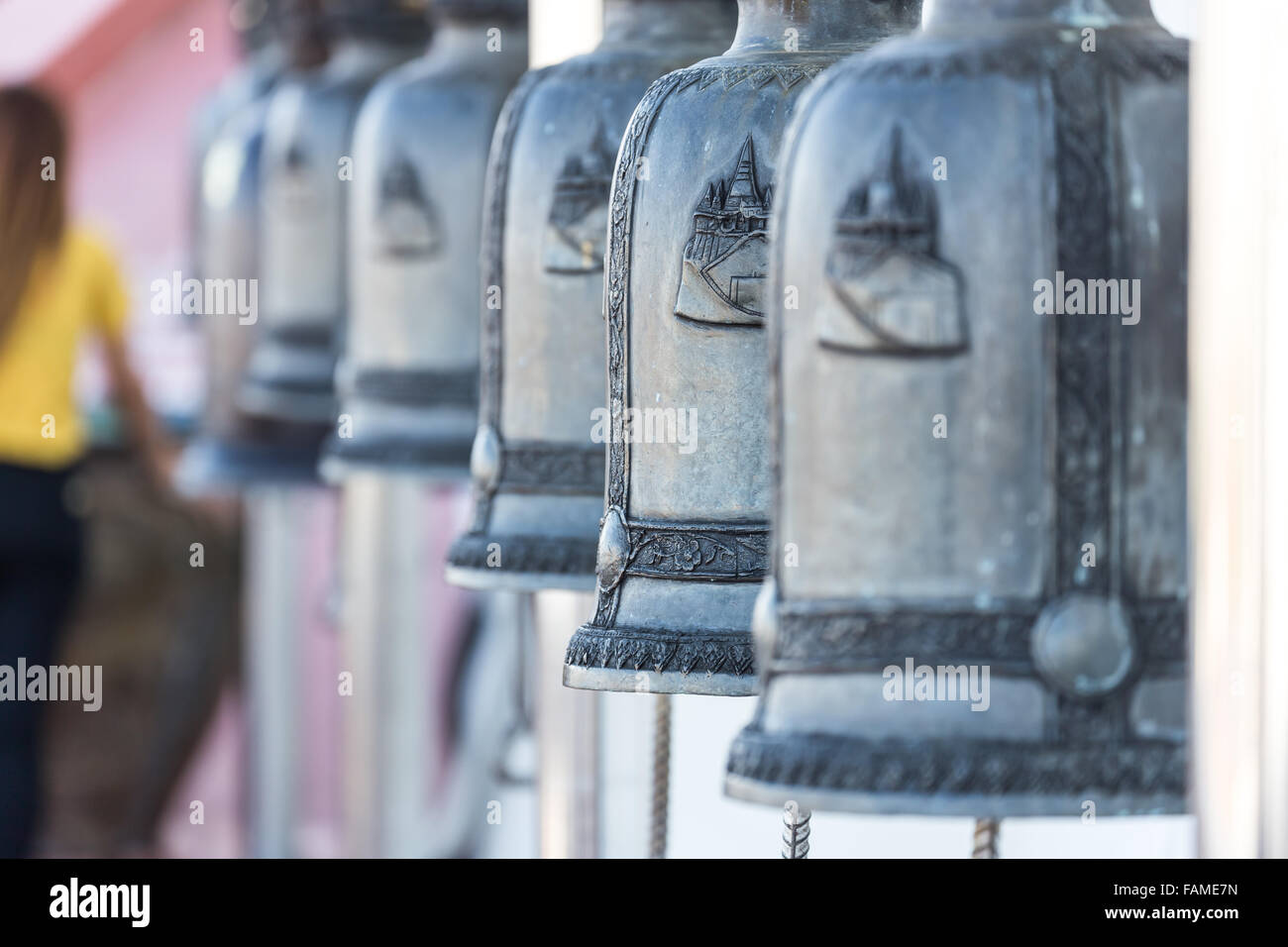 Close up onto big bells hang on the bar in public temple of Thailand ...