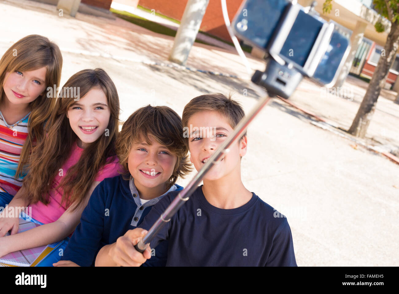 School kids talking photos with a selfie stick Stock Photo - Alamy