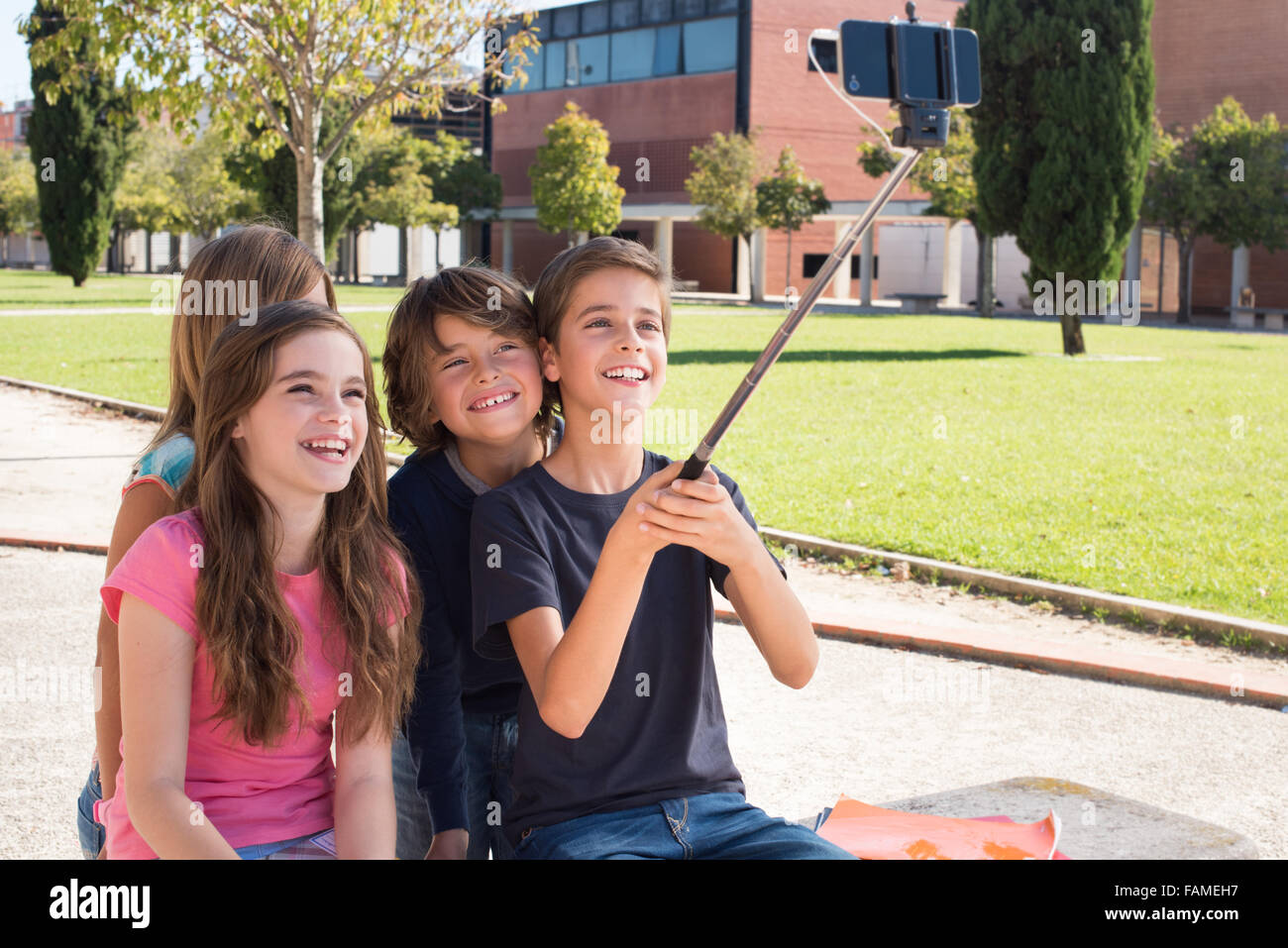 School kids talking photos with a selfie stick Stock Photo - Alamy