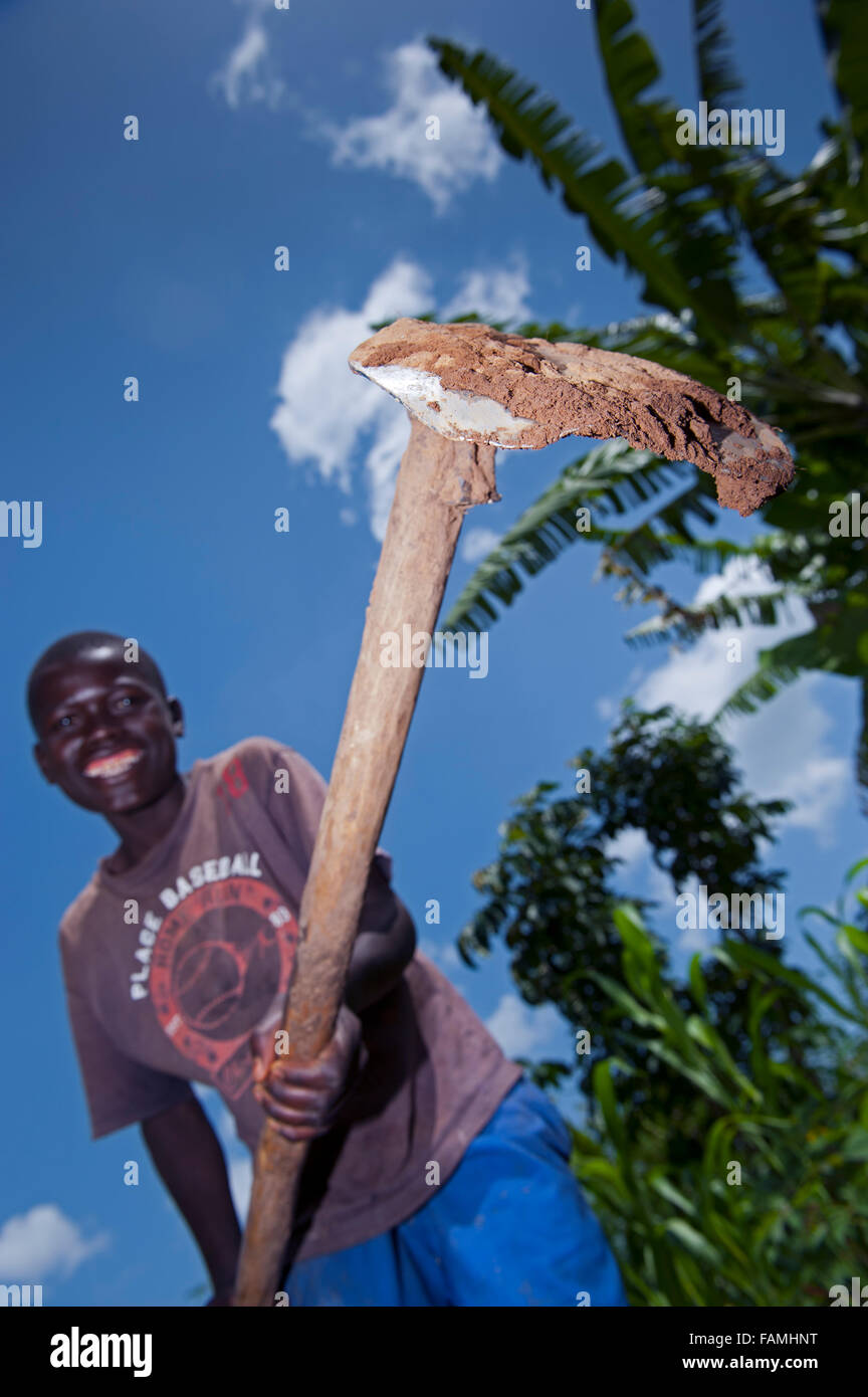 Young boy working in field with a traditional hoe. Kenya Stock Photo ...