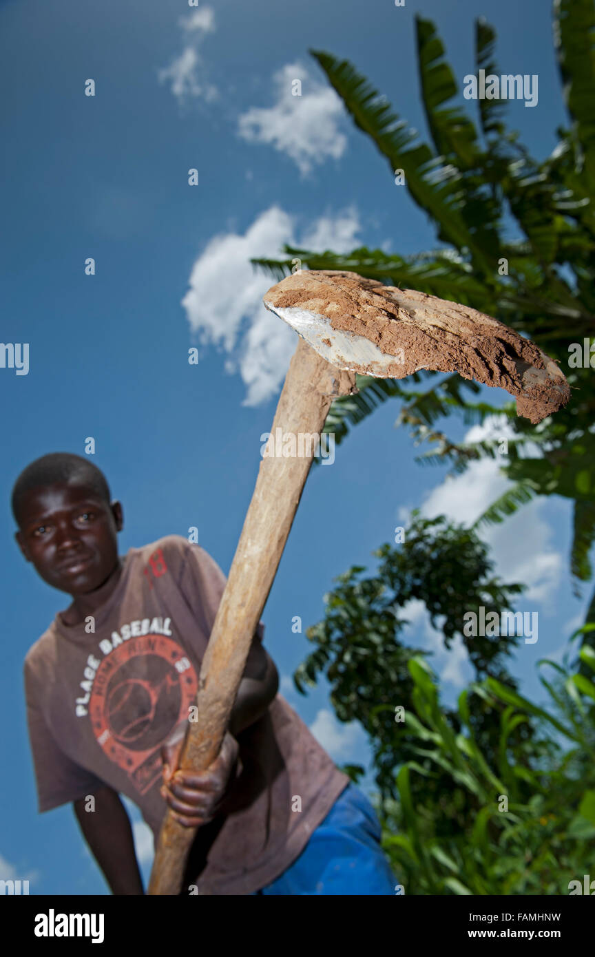 Young boy working in field with a traditional hoe. Kenya Stock Photo ...