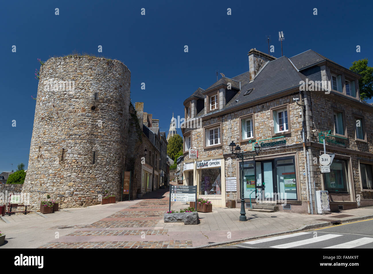 The historic medieval gate tower entrance to Domfront Castle, cobbled ...