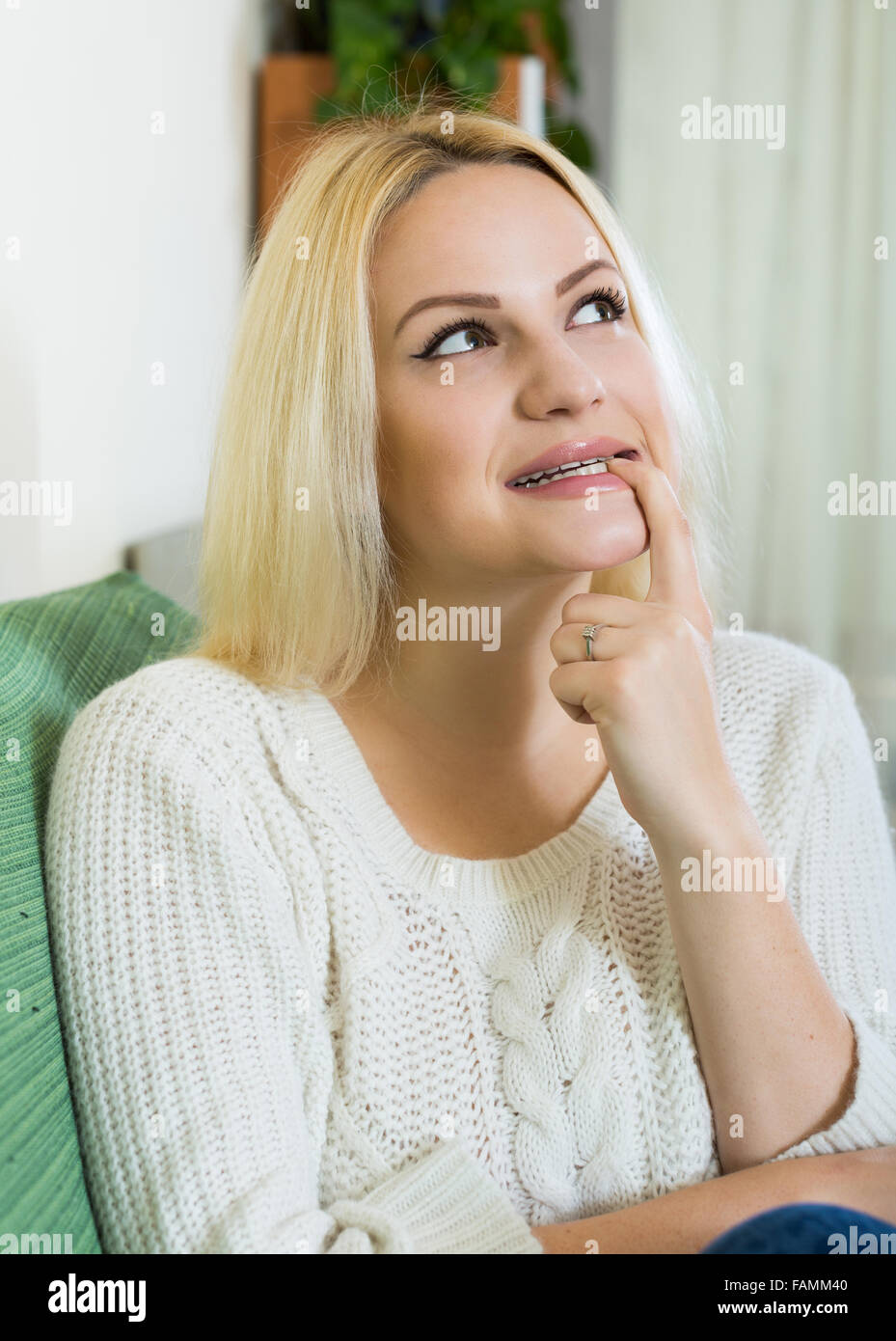 Portrait of positive young blonde woman with finger over lips Stock ...