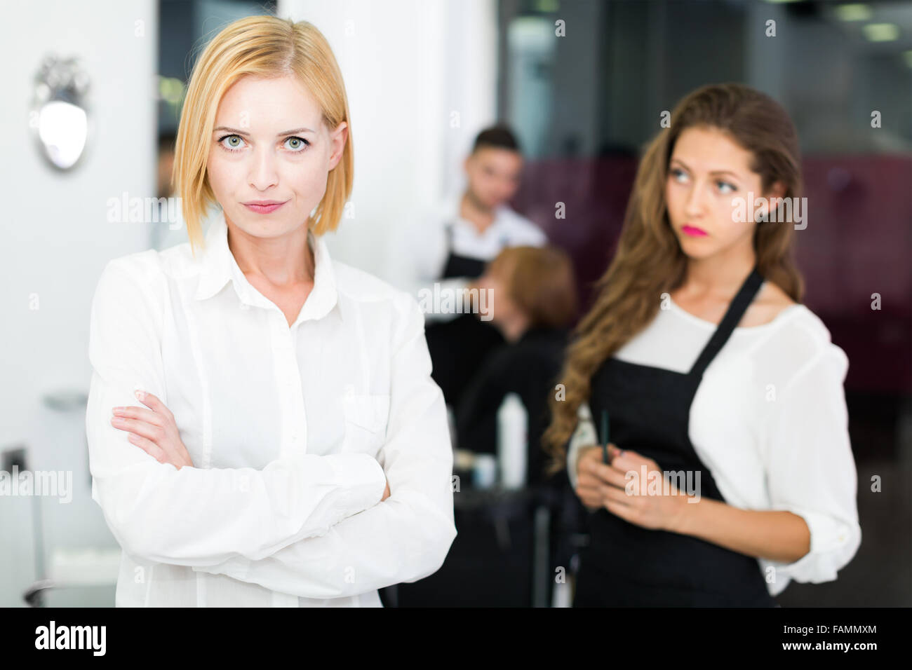 Sad client quarrels with barber in the barbershop Stock Photo - Alamy