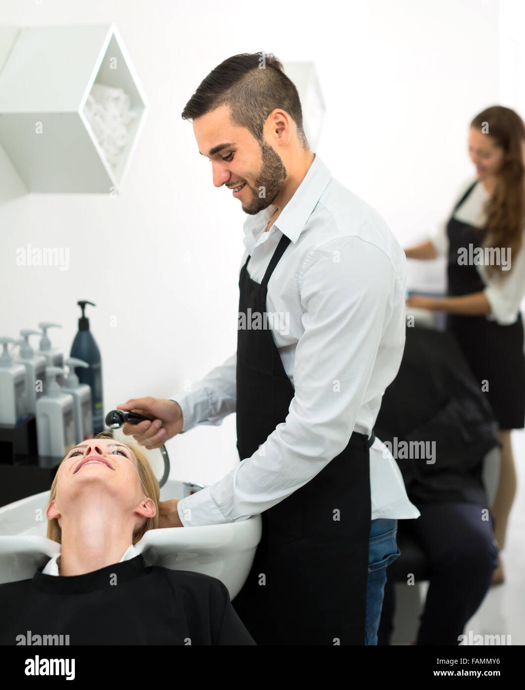 Barber washing the hair of customer at the hairdressing salon Stock ...