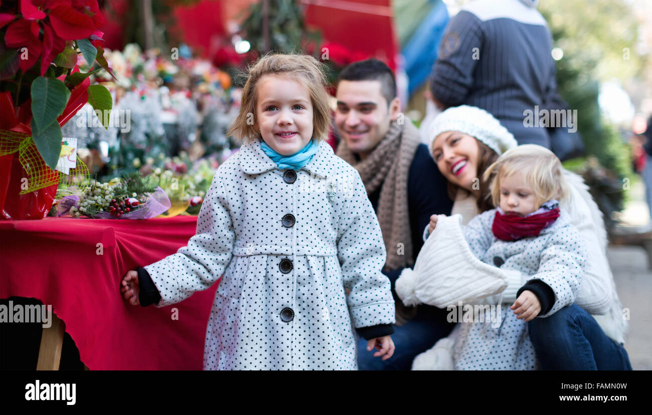 Positive married couple with two children choosing Christmas star ...