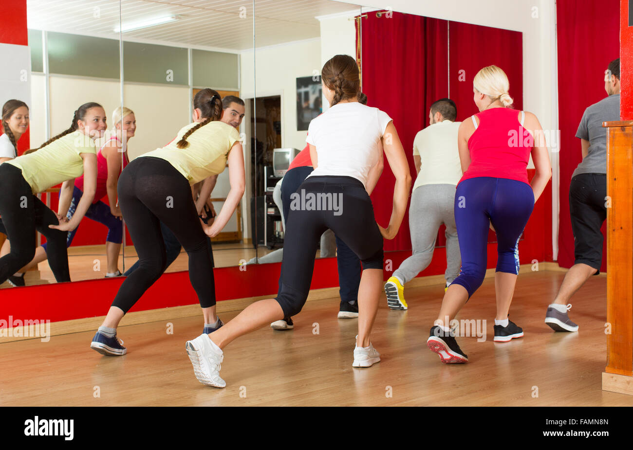 Group of smiling young adults dancing active dance in a studio Stock ...
