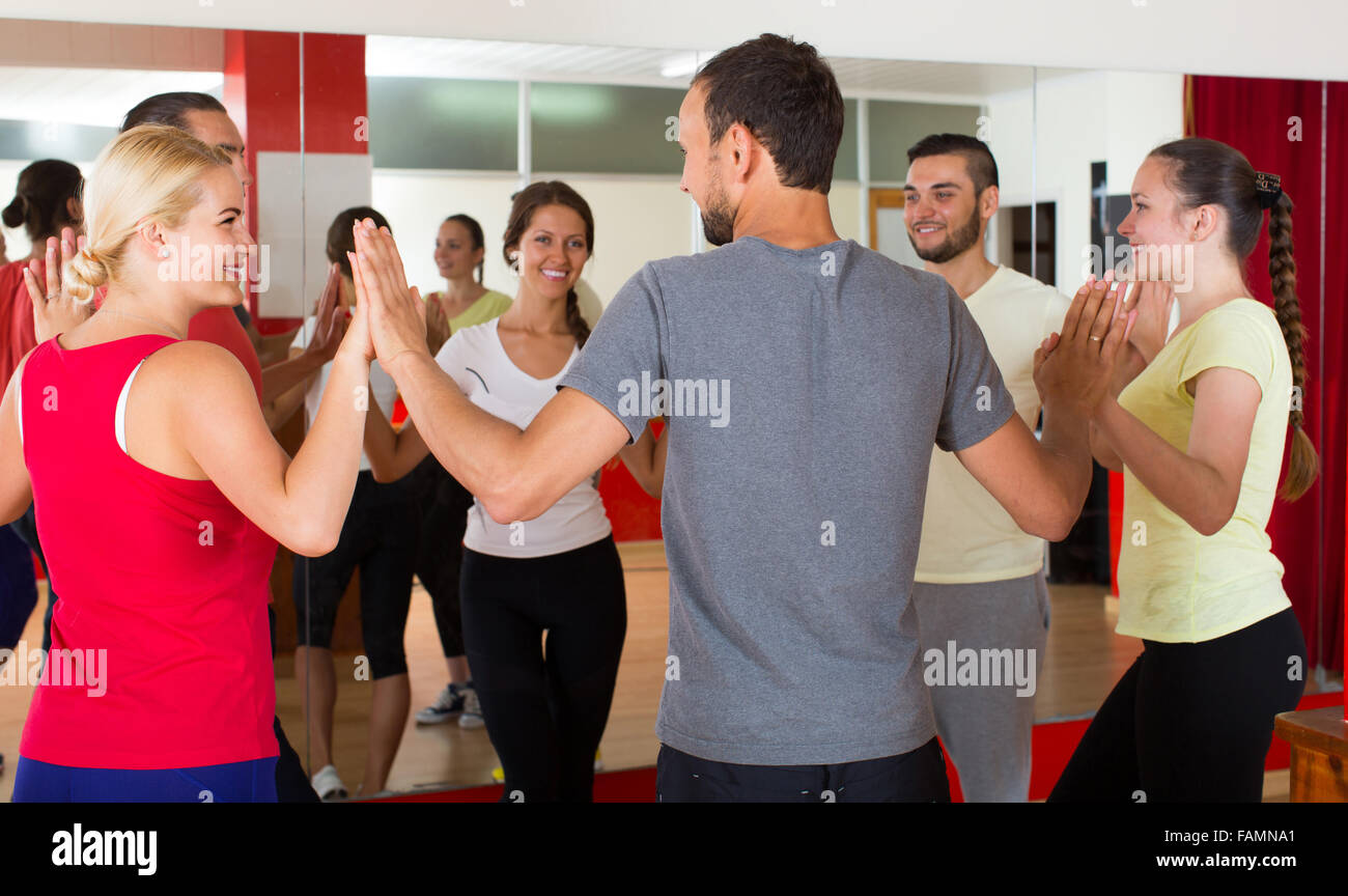 Group of happy american people dancing salsa in studio Stock Photo - Alamy