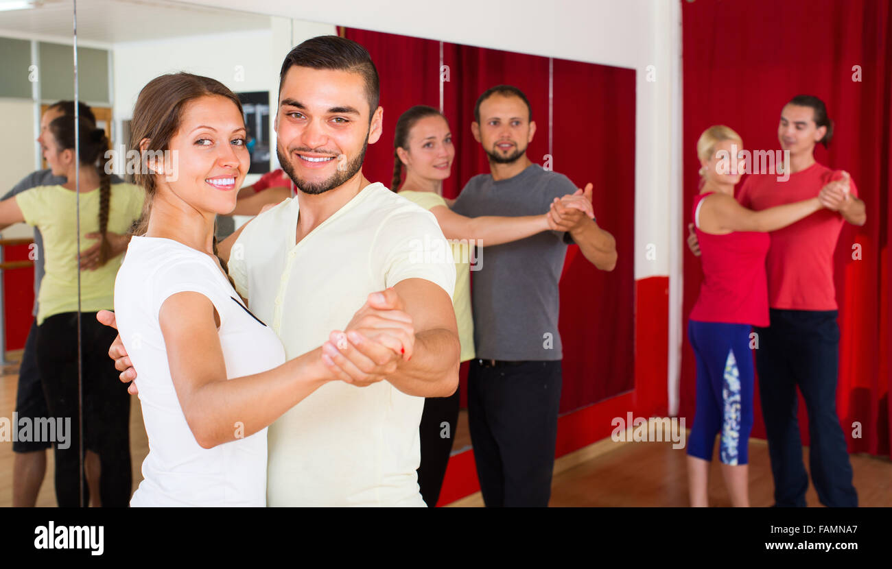 Smiling young couple enjoying of partner dance in dance class Stock ...