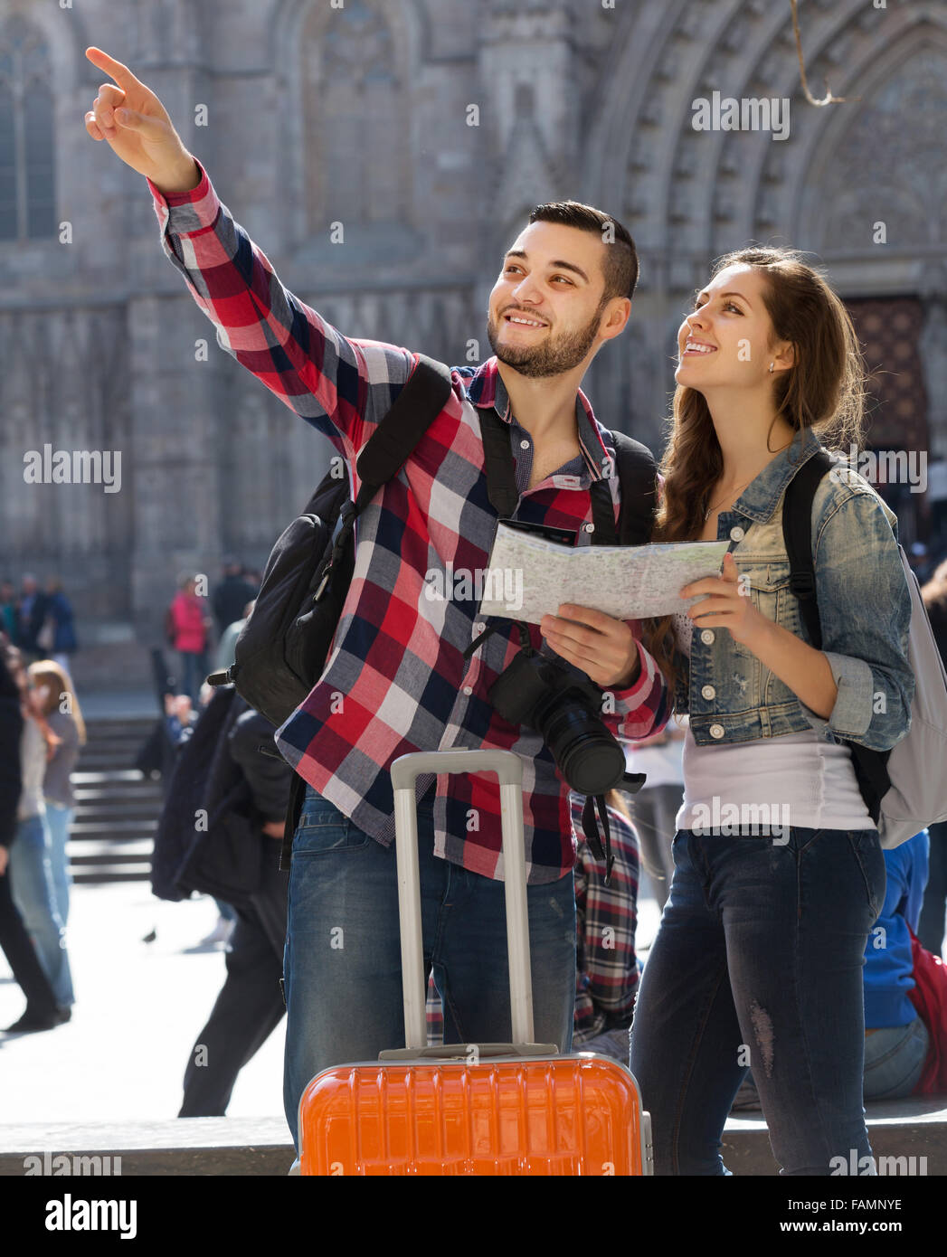 Positive young man points the direction at the city Stock Photo - Alamy