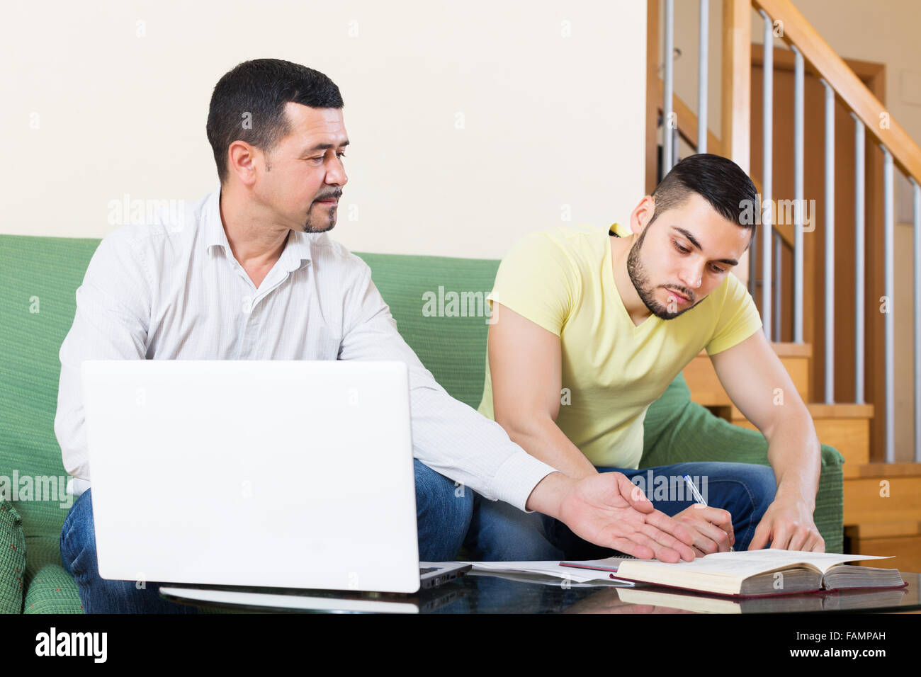 Professor giving private lesson to serious student at home Stock Photo ...