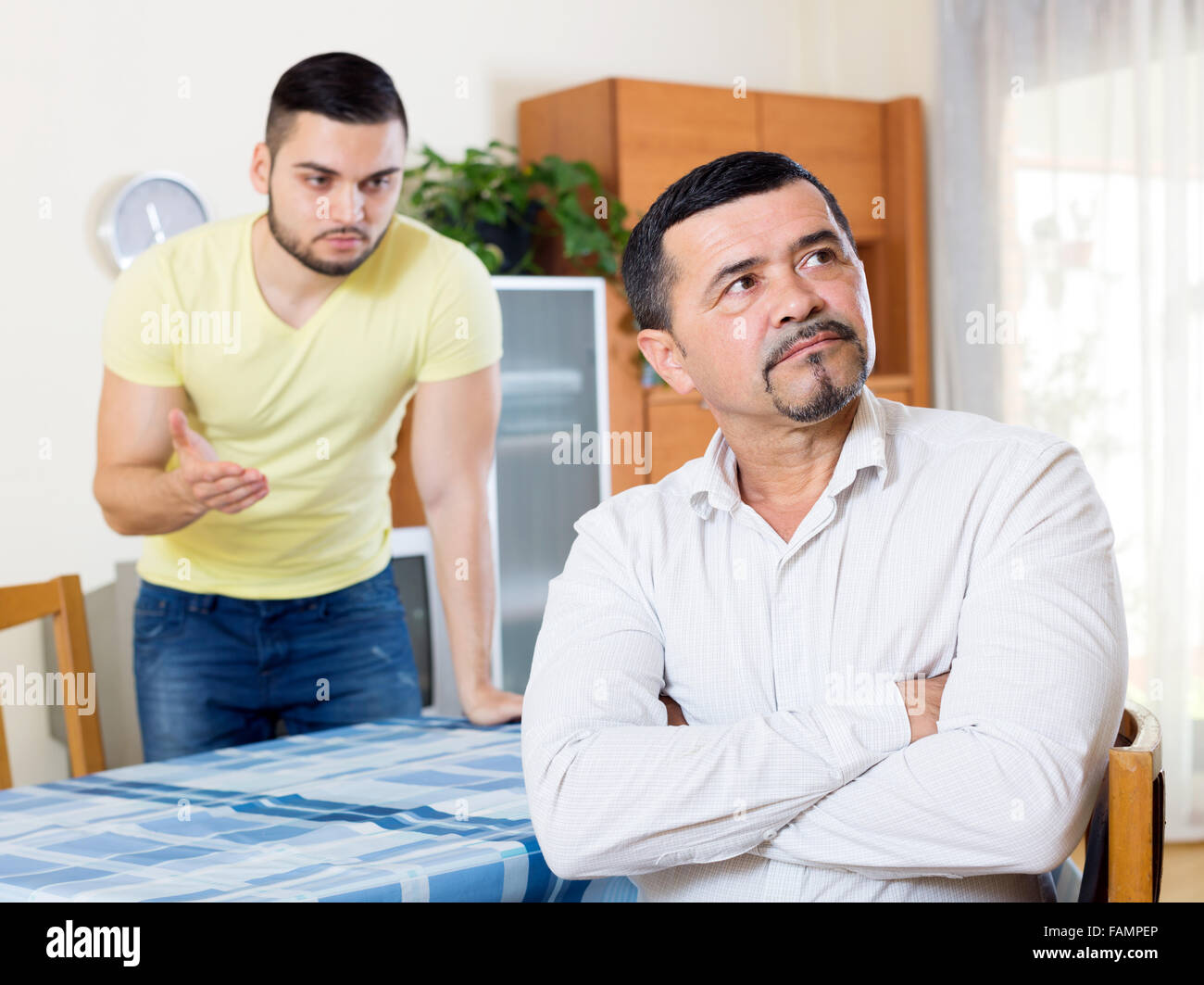 Domestic quarrel between senior father and young son Stock Photo - Alamy