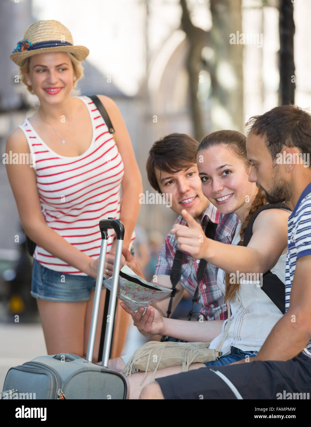 smiling tourists with map exploring the city destination Stock Photo ...