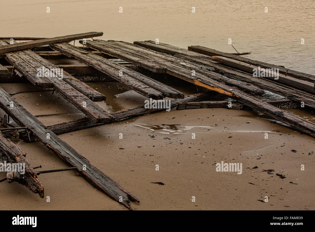 Washed up dock on beach Stock Photo - Alamy