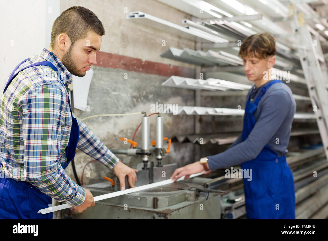 Couple of adult men are working around the milling machine Stock Photo ...