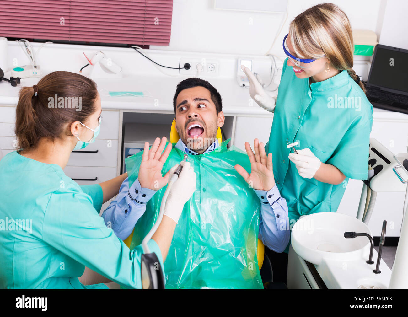 Scared client and dental clinic crew during check up Stock Photo - Alamy