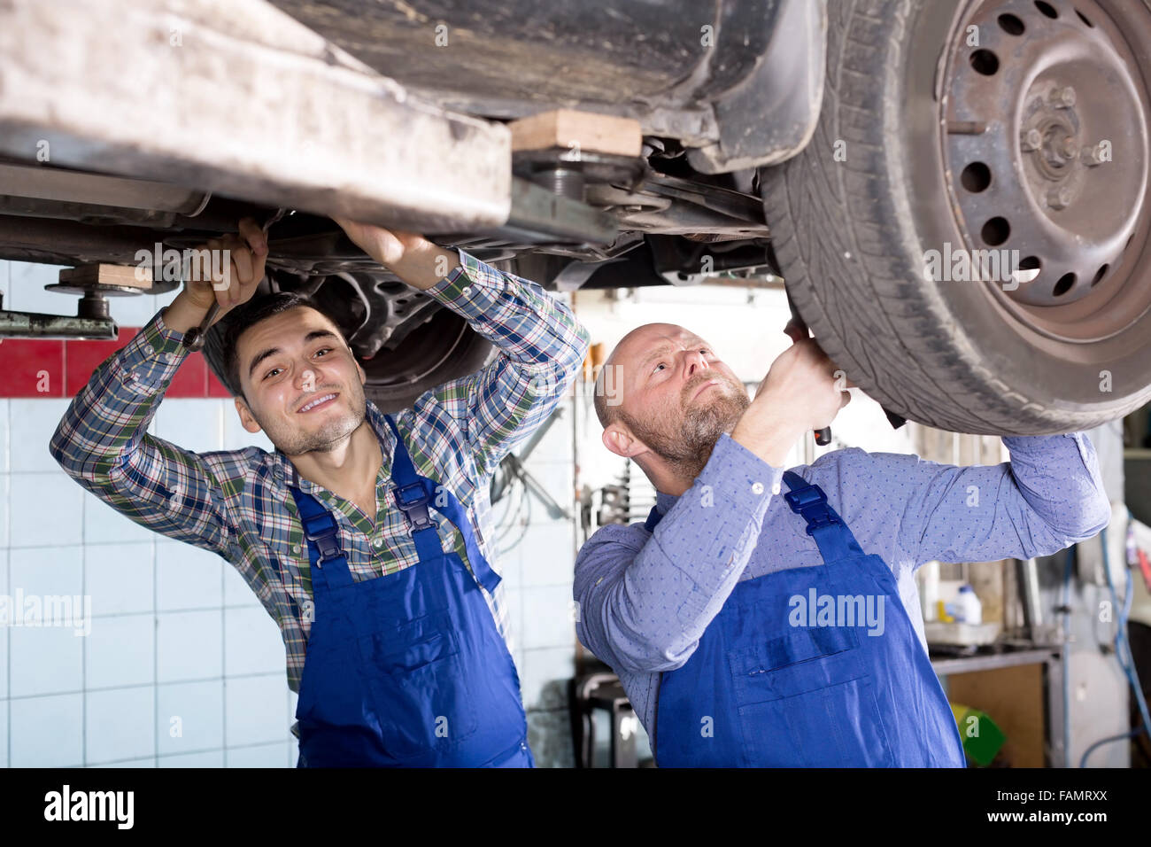 portrait smiling two men in coveralls working at auto repair shop Stock ...