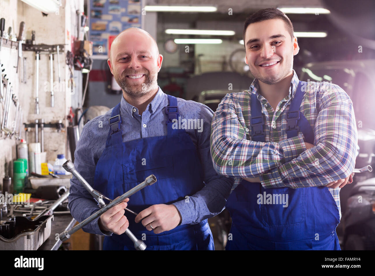 Portrait of two happy garage workmen near facilities Stock Photo - Alamy
