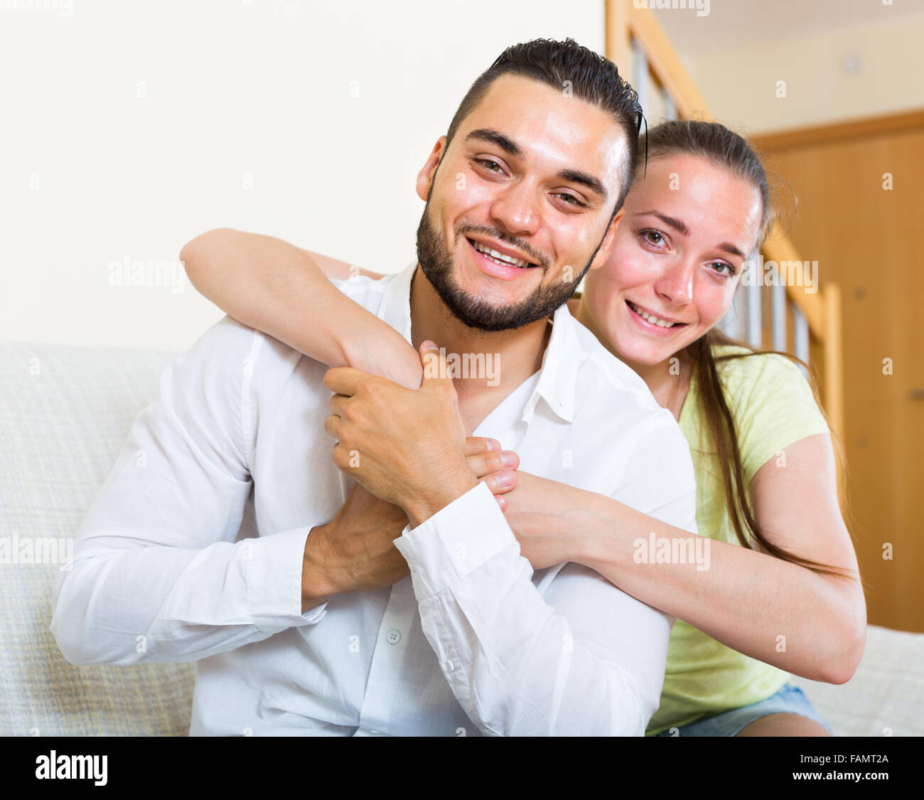 Happy romantic pair smiling and embracing indoors Stock Photo - Alamy